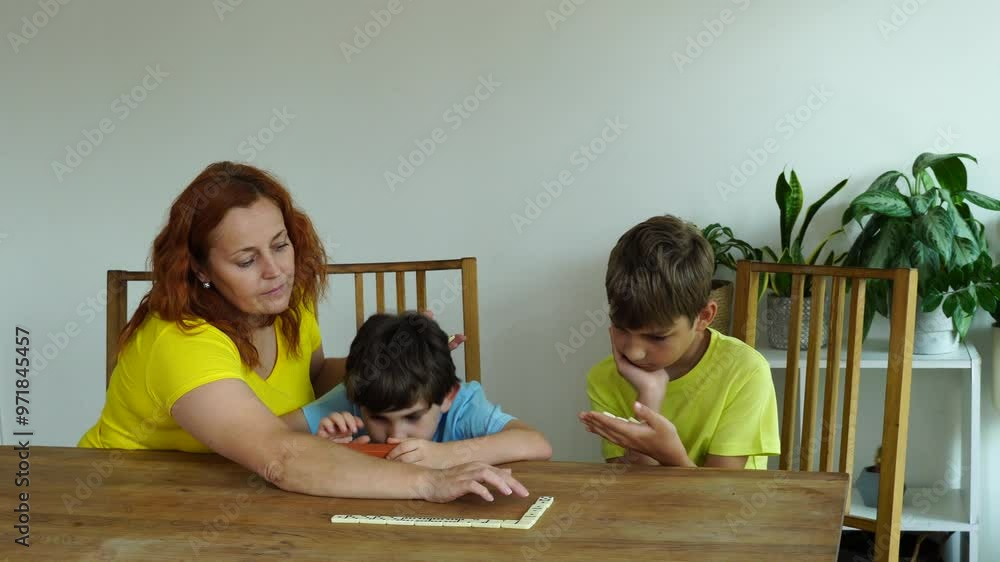 Mother shows kids how to play domino, board game and time together ...