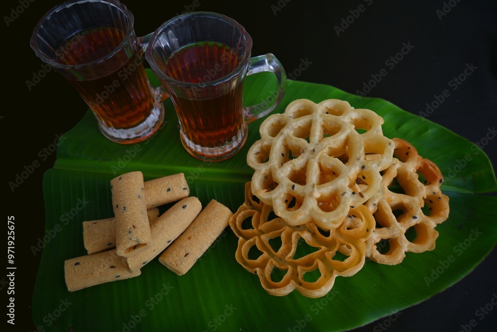 Achappam, rose cookies, kuzhalappam with black tea in banana leaf ...