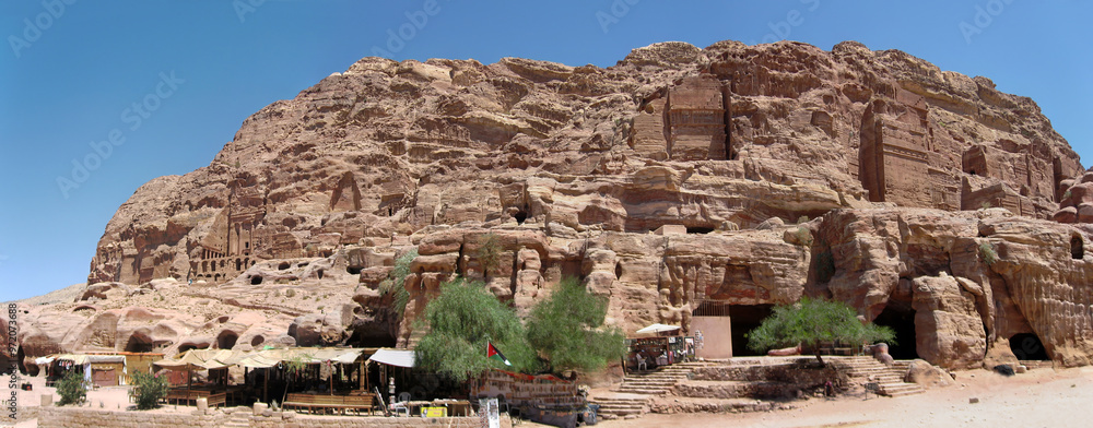 Panoramic view of Ancient temples carved in rock face in Petra Street ...