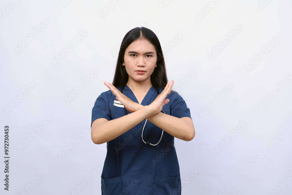Serious asian woman nurse in blue uniform crossing her arms to form an ...