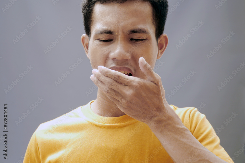 Asian men have bad breath caused by swollen gums, stomach problems and ...