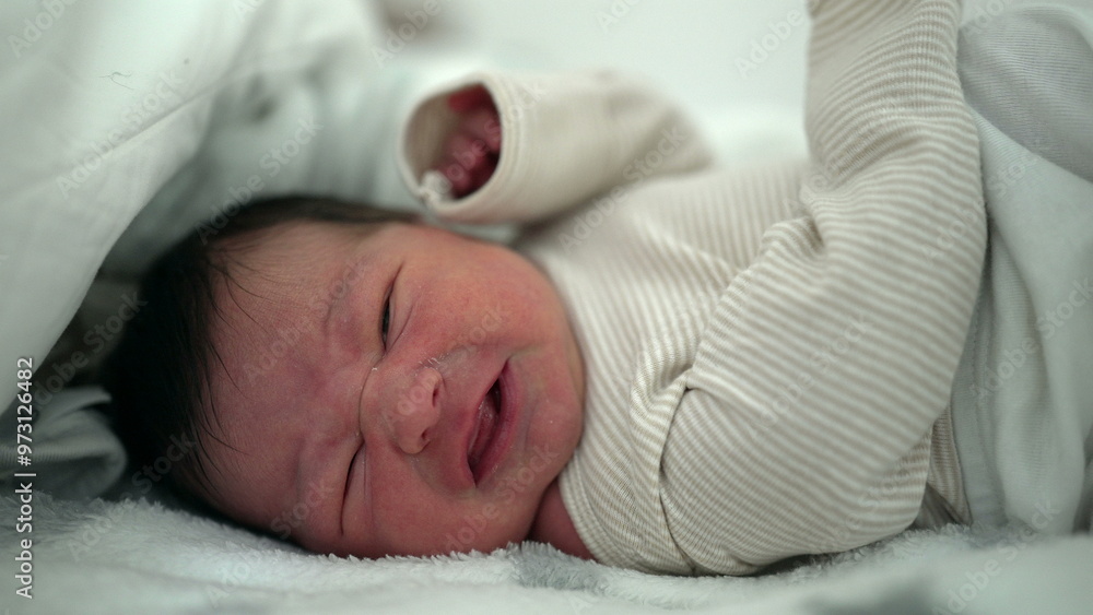 Newborn baby crying in bed, showing a raw and emotional moment. the ...
