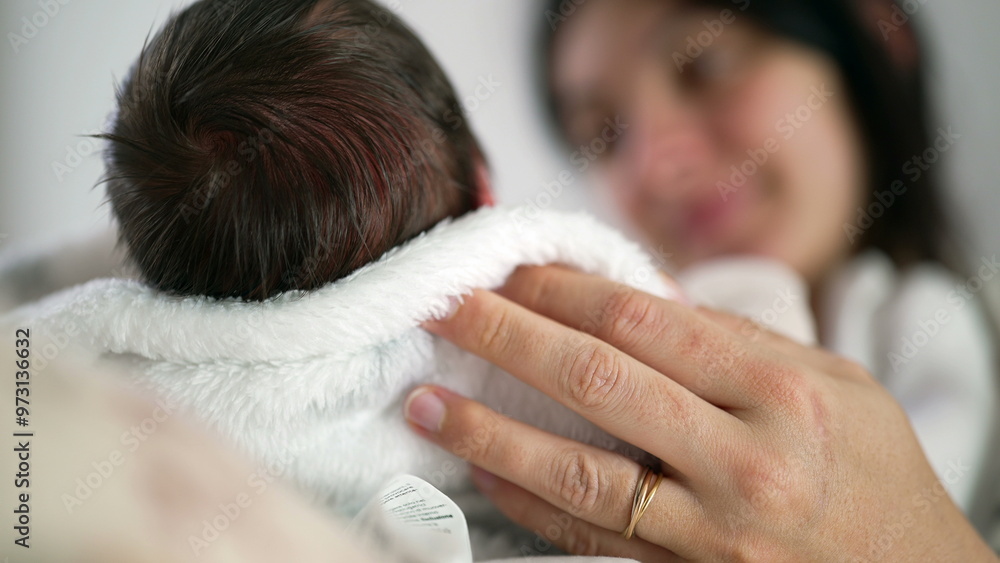Mother holding her newborn baby from behind, focusing on the baby’s ...