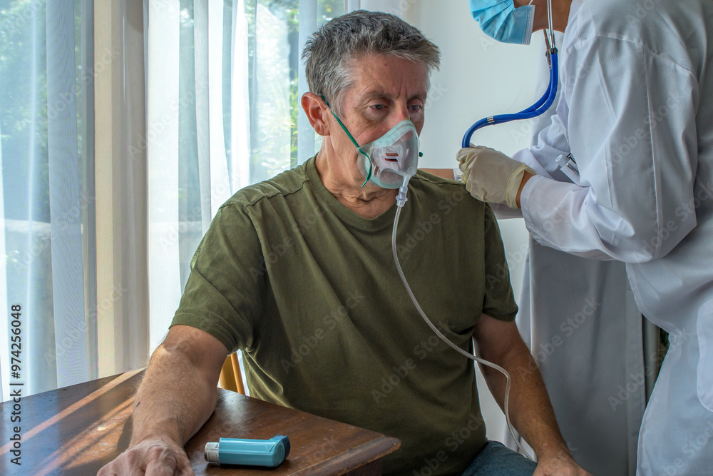Oxygen face mask is placed on a man with breathing difficulty due to ...