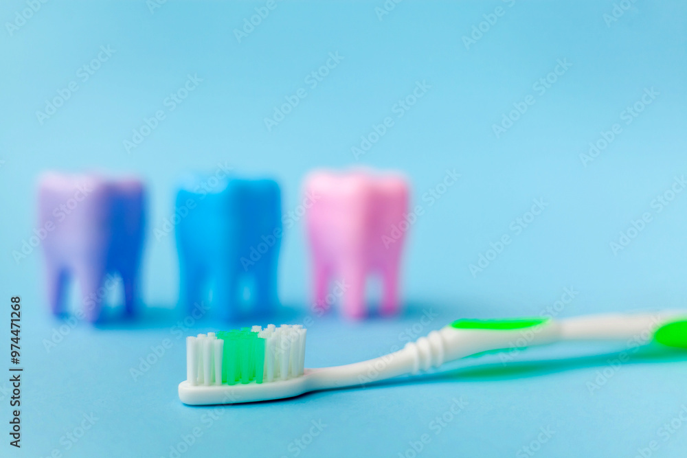Toothbrush and three colorful teeth on a blue background. Teeth on a ...