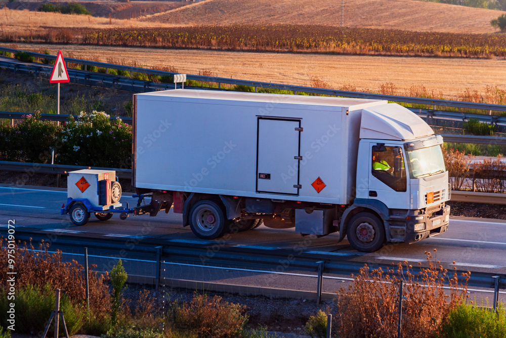 Truck with ADR explosive hazard labels, with a trailer transporting the ...