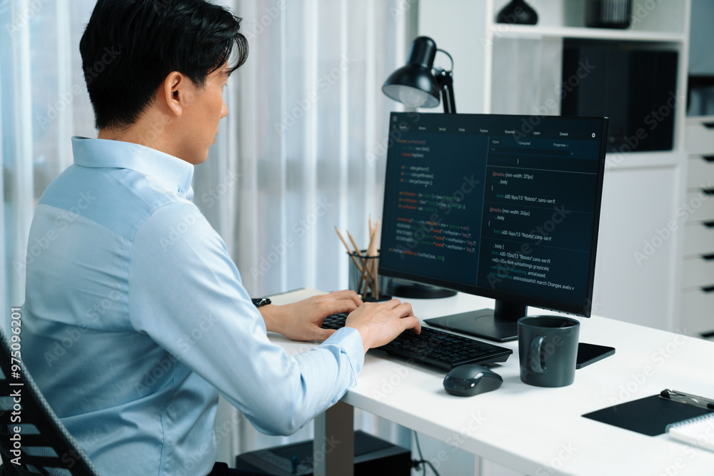 Smart IT developer looking at coding program application on computer ...