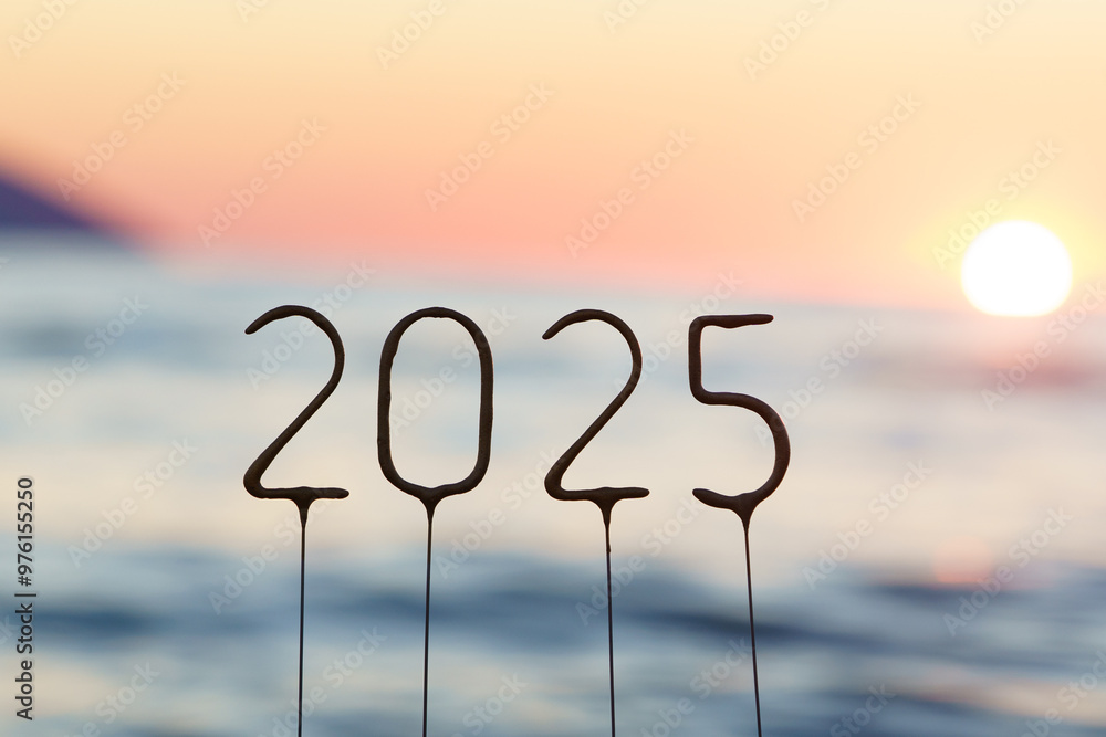 Numbers 2025 year on the background of the setting sun and pink sunset ...