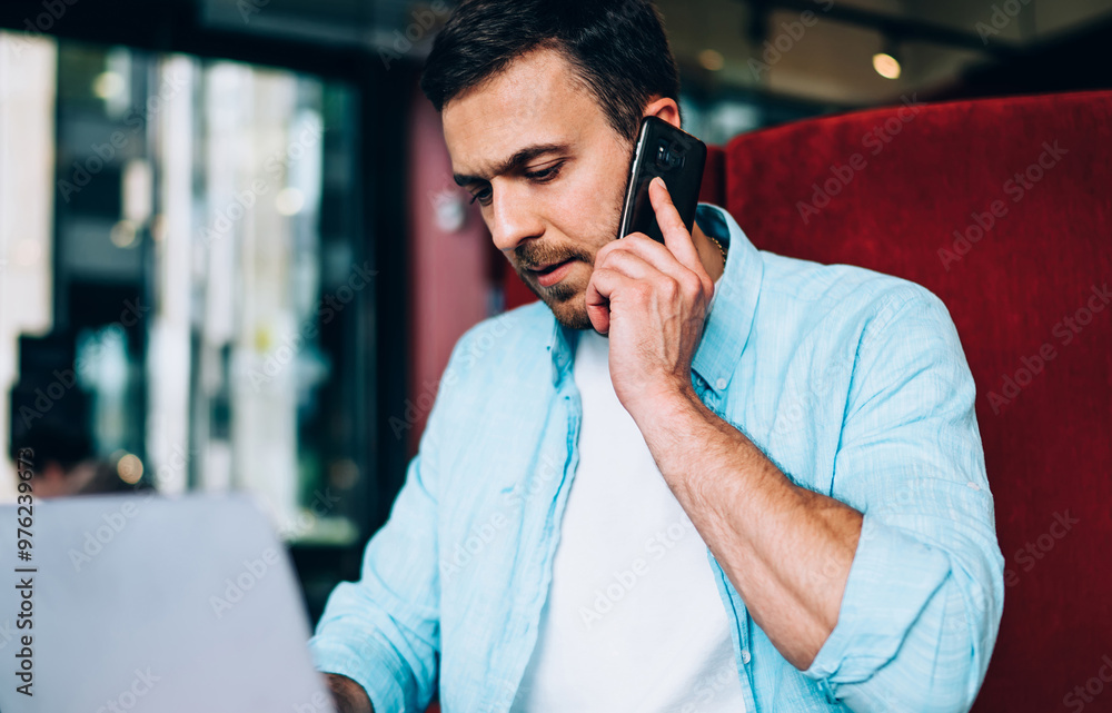 Serious freelancer doing remote work calling to customer service for ...