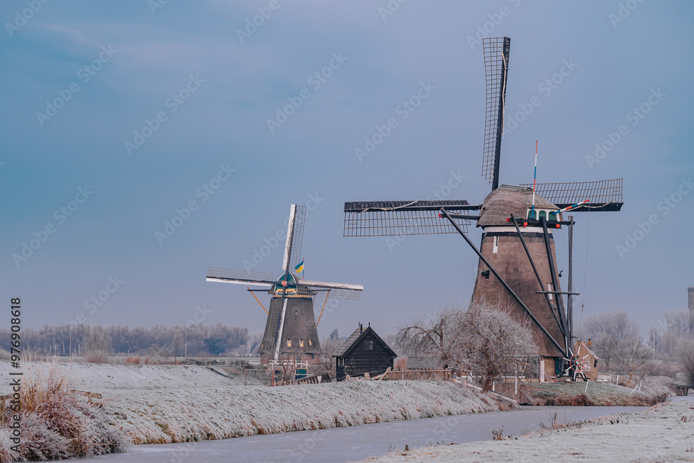 Historic windmills in the frozen period of winter. Medieval ...