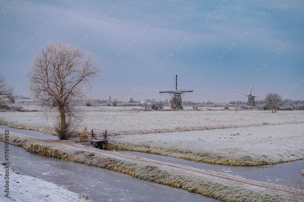 Historic windmills in the frozen period of winter. Medieval ...