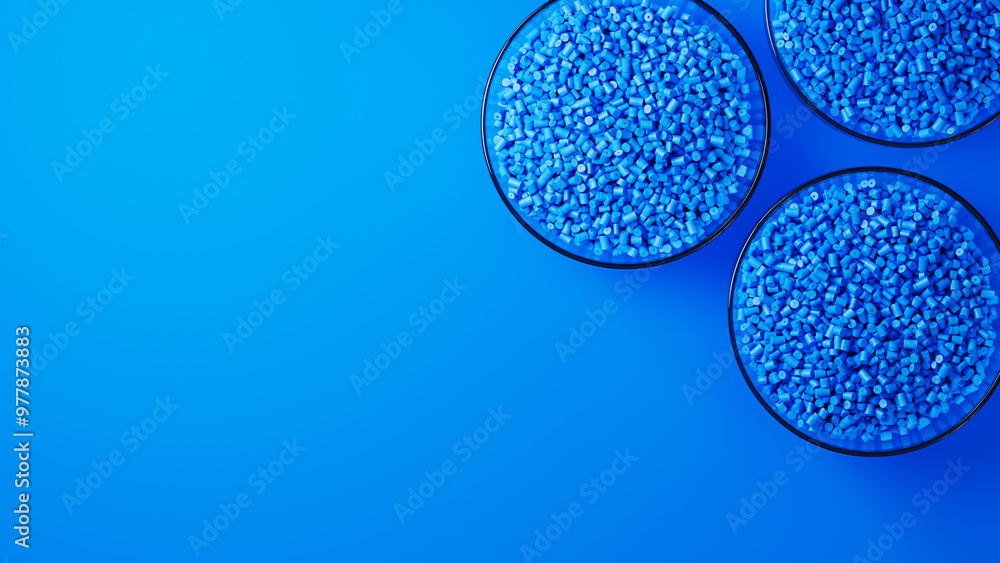 Top view on three glass cups with blue plastic polypropylene granules ...
