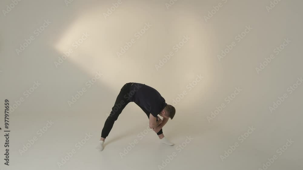 Dynamic Dance Pose Captured in a Minimalist Studio Setting with ...