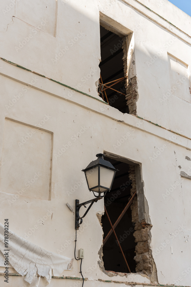 old building with parts of the façade collapsed and undergoing ...