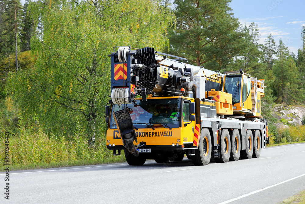 Liebherr LTM 5-axle mobile crane driving along highway on a day of ...