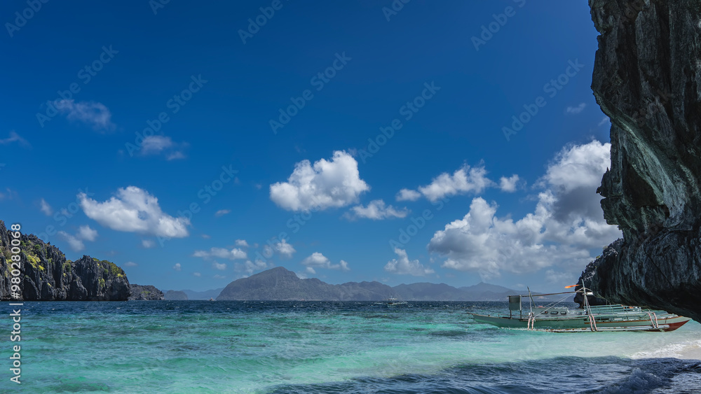 The traditional Filipino bangka boat is moored off the shore of the ...