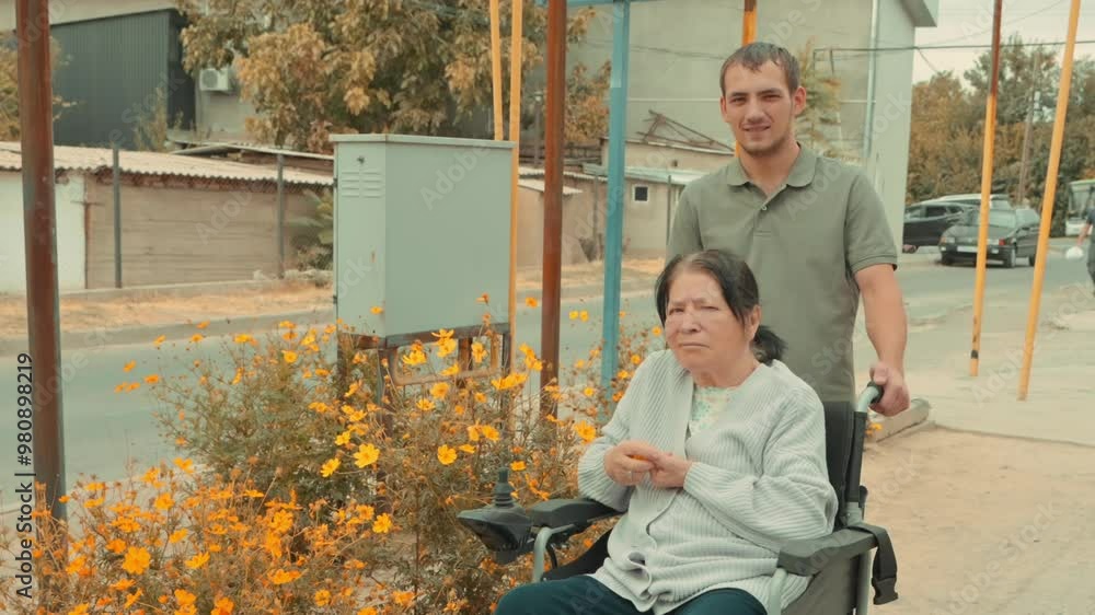 man caring for disabled mother in wheelchair, Sad senior woman sitting ...