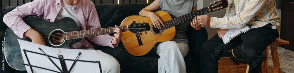 Group of people holding acoustic guitars practicing chords during music ...
