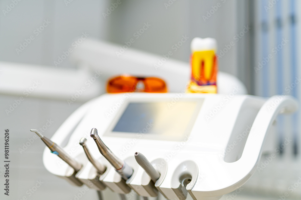 Modern dental tools in clinic. A dental station displaying various ...