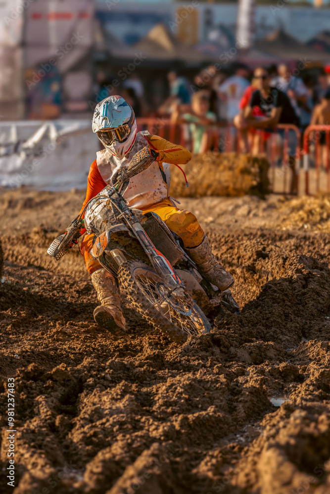 Motocross rider in action twisting and turning his motorcycle as he ...