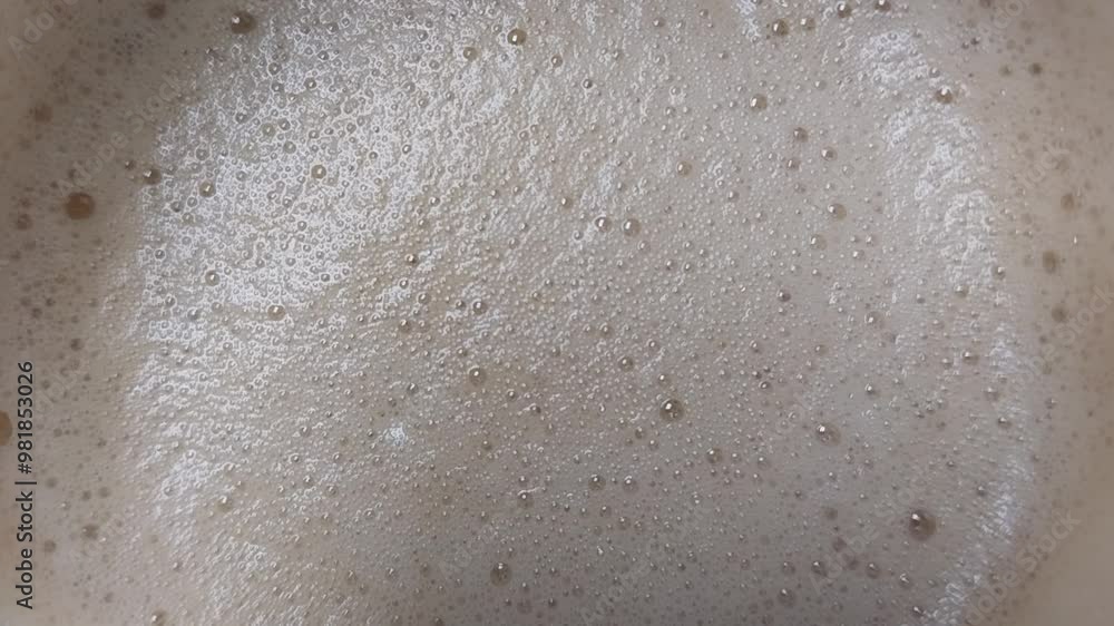 a close-up view of a frothy or bubbly surface, which appears to be a ...