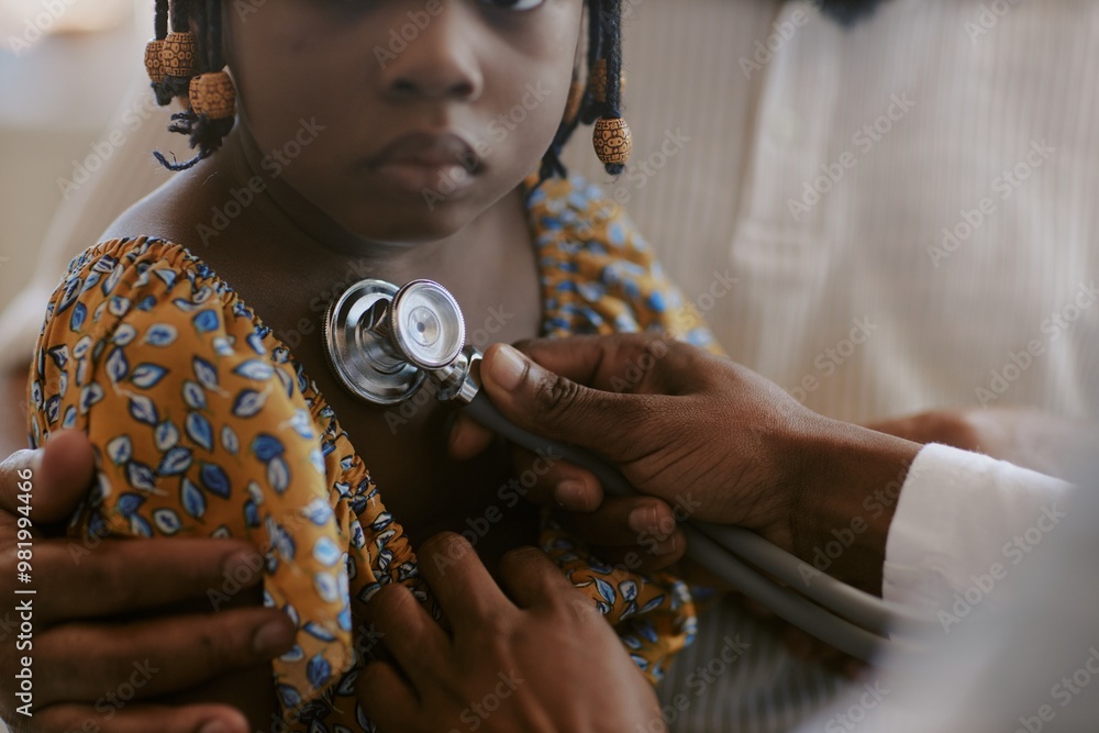 Portrait of child receiving medical examination with stethoscope ...