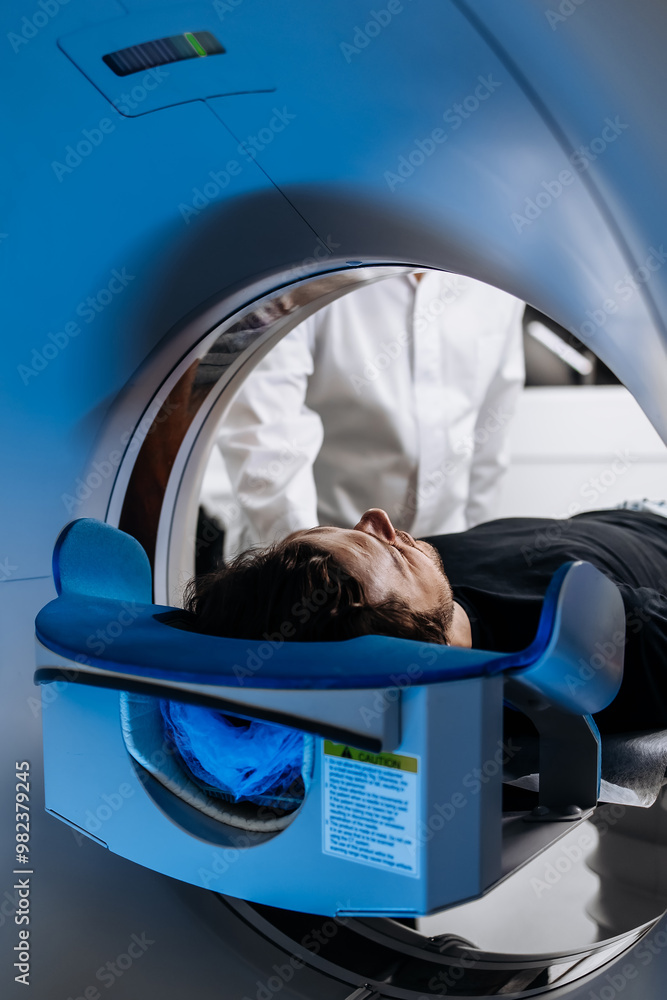 A medical CT or MRI machine is located in a diagnostic clinic, showcasing advanced imaging ...