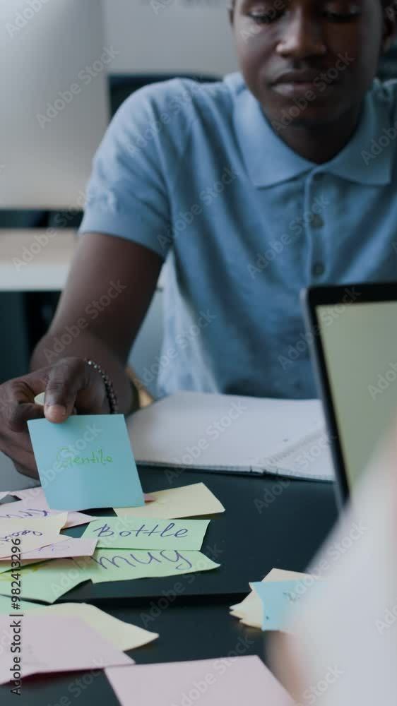 Vertical waist up shot of intercultural young adult student learning ...
