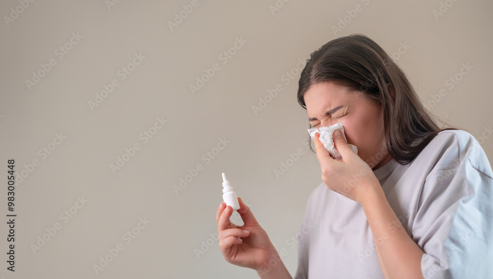 Poster Nasal hygiene with spray, girl clears nasal passages by blowing ...