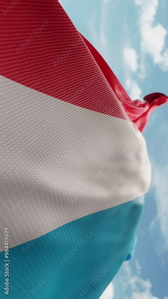 Wavy flag of Luxembourg blowing in the wind in slow motion. Waving official Luxembourg flag team ...