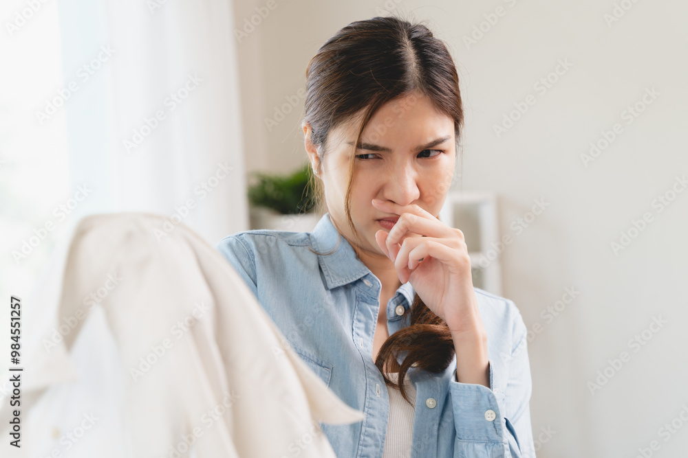 Smelly clothes laundry, housewife woman having bad smelling clothes on ...