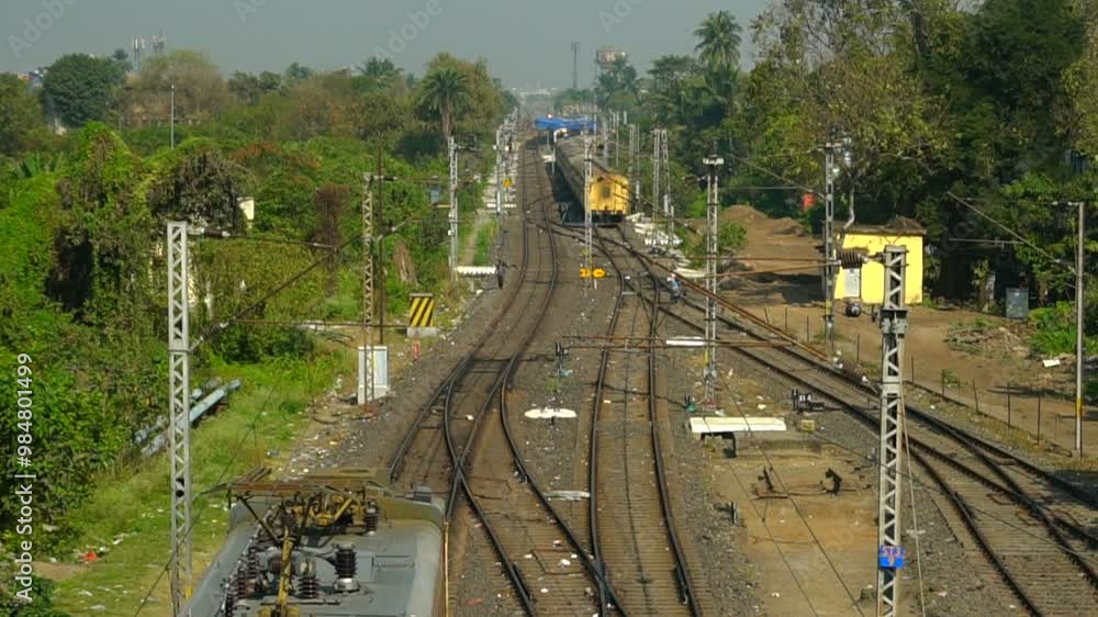 Slow motion video of passenger train passing through rail track while ...