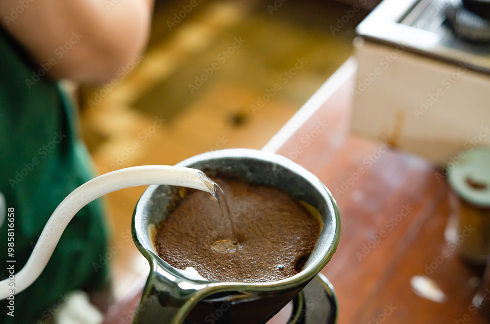 drip coffee Barista making drip coffee by pouring spills hot water on ...