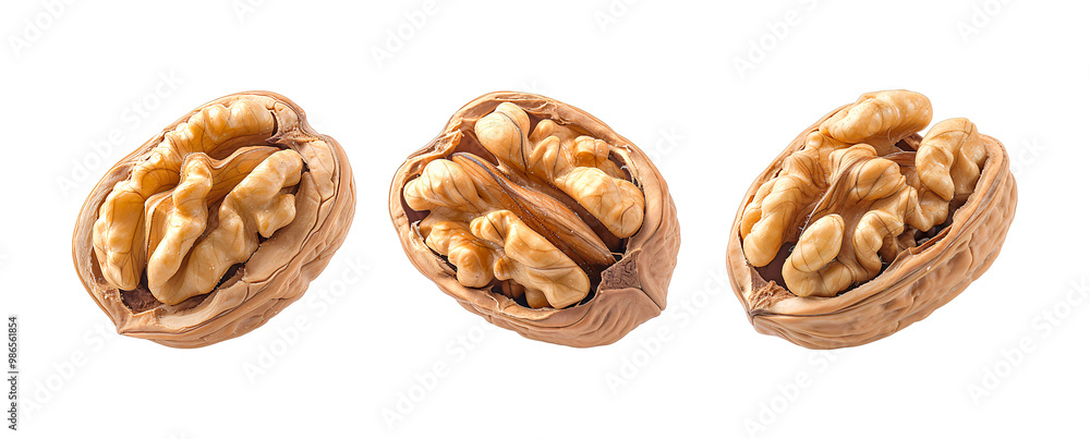 Three walnuts in shells one halved revealing the nut inside on a ...