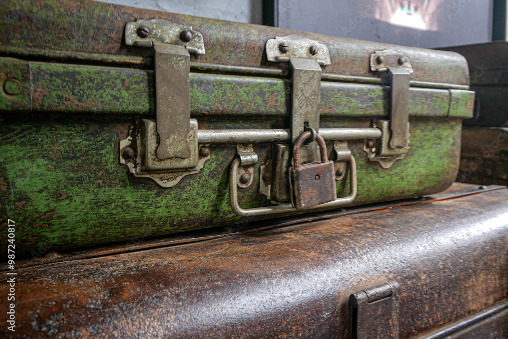 A pile of ancient, rusty suitcases complete with locks and latches that ...