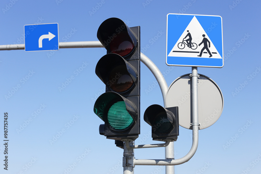 Green traffic light signal with right turn arrow at intersection ...