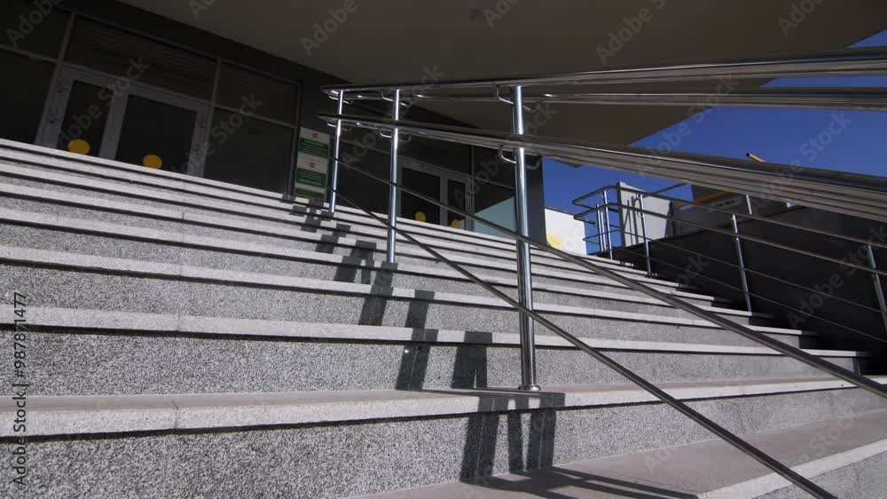 Granite steps with shiny chrome handrails at school building entrance ...