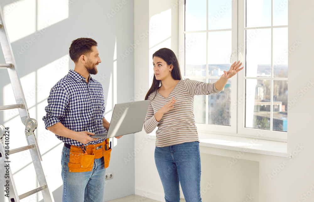 Young woman talking to a repairman who is going to make repairs in her ...