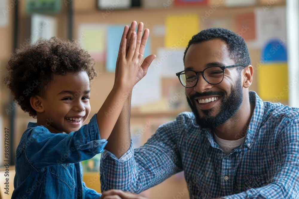 Happy black elementary student and his teacher greet with high five ...