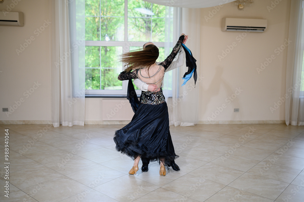 Graceful male and female ballroom dancers in stage costumes perform ...
