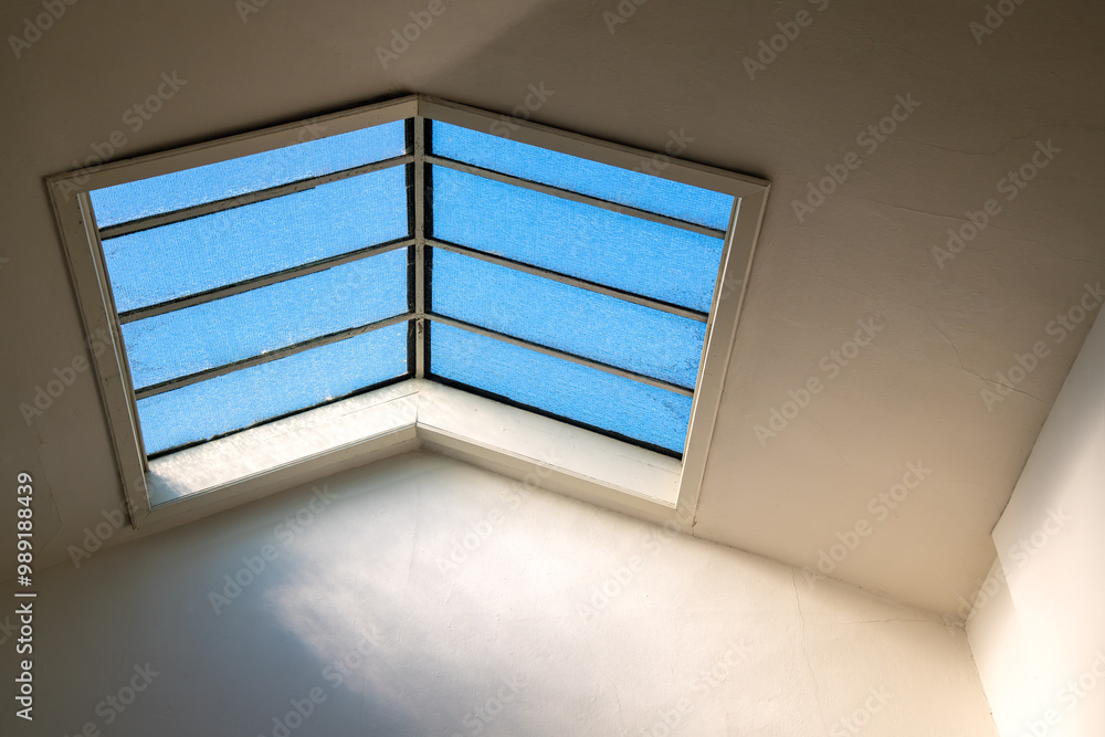View from below through a glass skylight made of safety glass. The blue ...