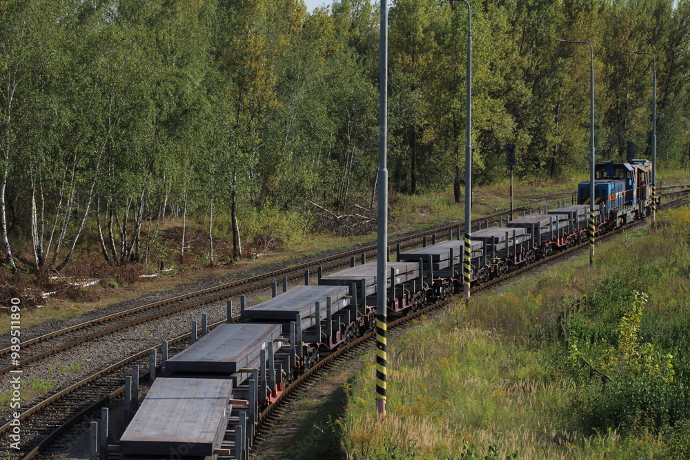 Train transporting big metal and concrete blocks. Goods train ...