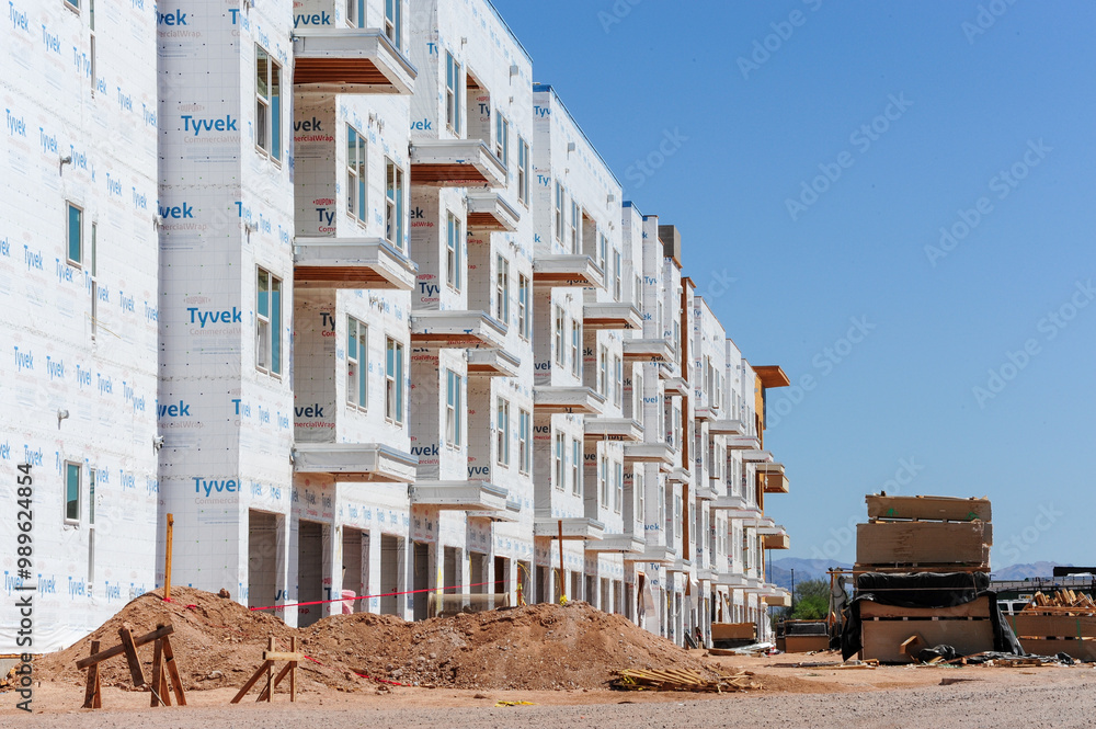 Exterior view of apartment buildings under construction, wrapped in ...