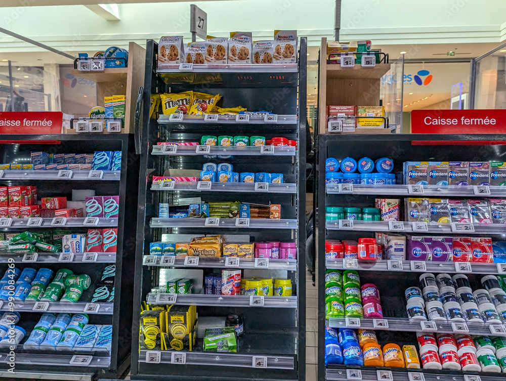 France, 20 August 2024 : Store shelves with candy, gum, cookies, closed ...