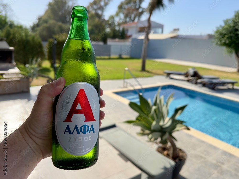 Rhodes, Greece - June 24, 2024: A bottle of Alpha beer, a lager brewed ...