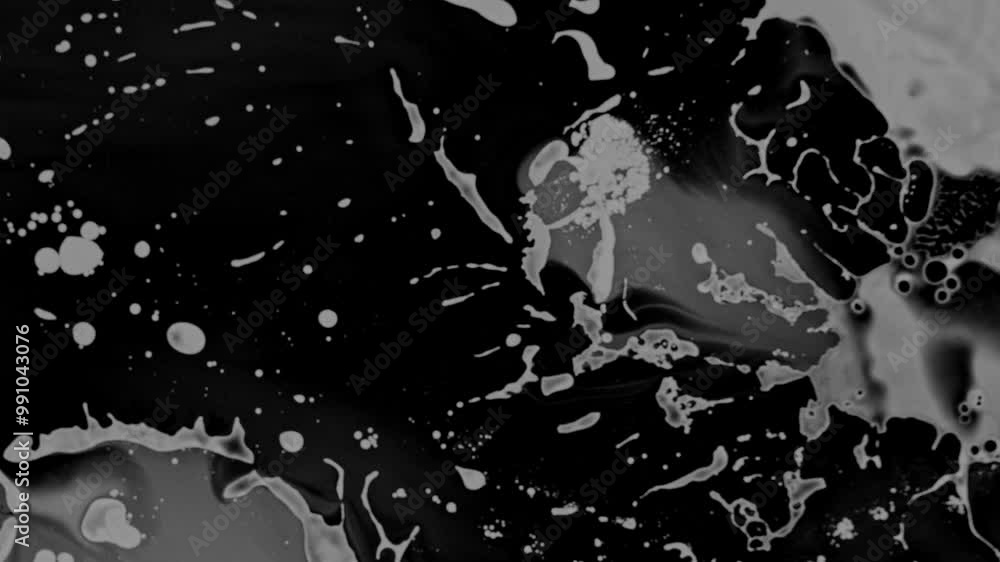 Abstract black and white image featuring splattered liquid patterns ...