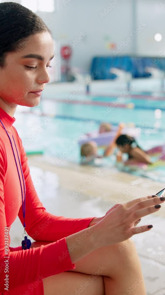 Coach, swimming pool and woman with smartphone, distracted or jeopardy ...