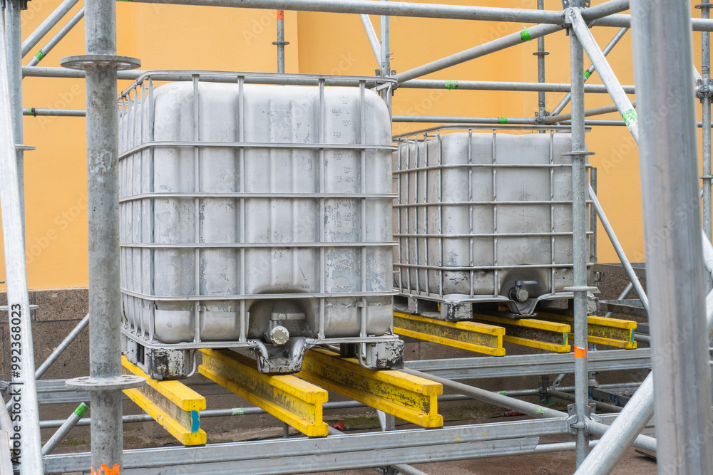 IBC tanks on scaffolding. Engineering structures to build house. IBC ...