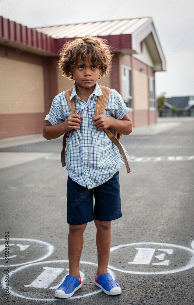 Young diverse elementary school student with an grumpy and ...