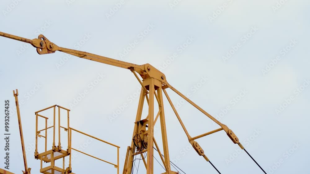 Pulley blocks rotate on construction crane. Construction site with ...